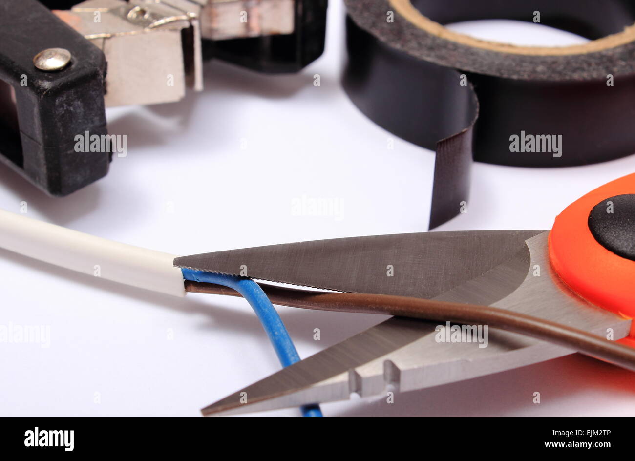 Cable cutter, electric wire and black insulating tape on white ...
