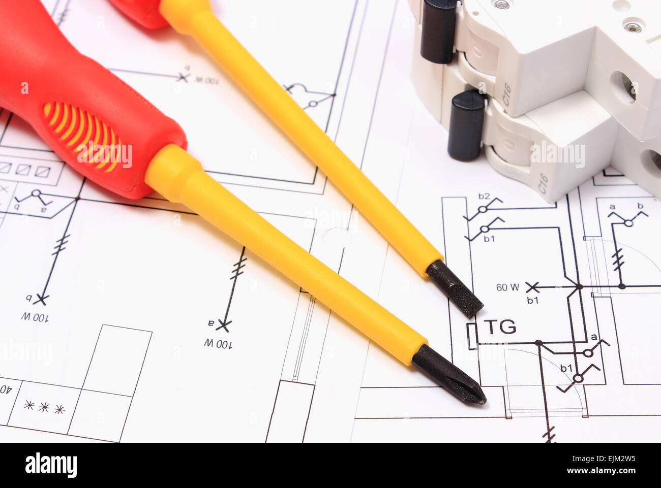 Screwdriver, work tools and electric fuse lying on construction drawing ...