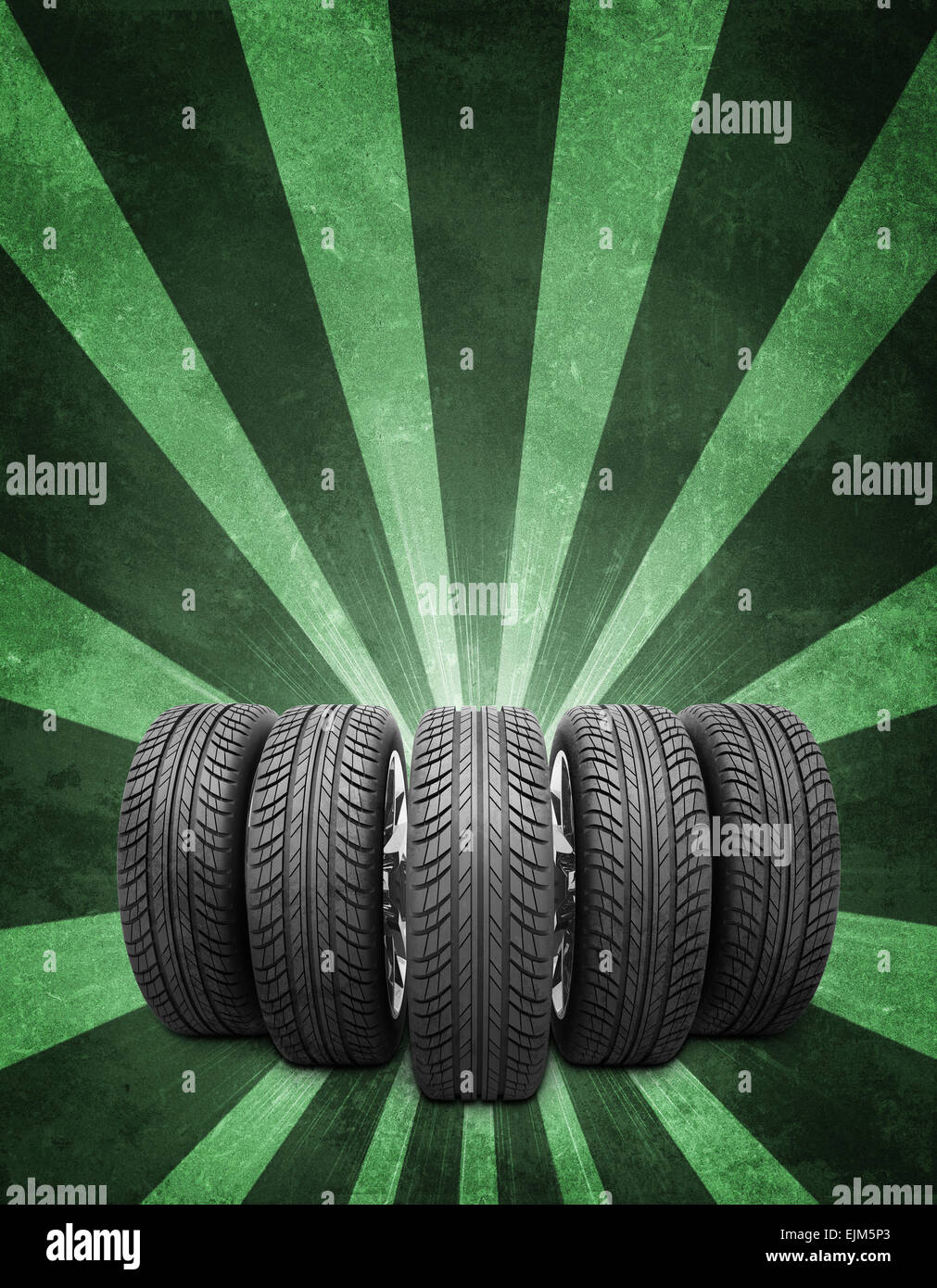 Wedge of new car wheels. Green background is concrete and stripes at ...
