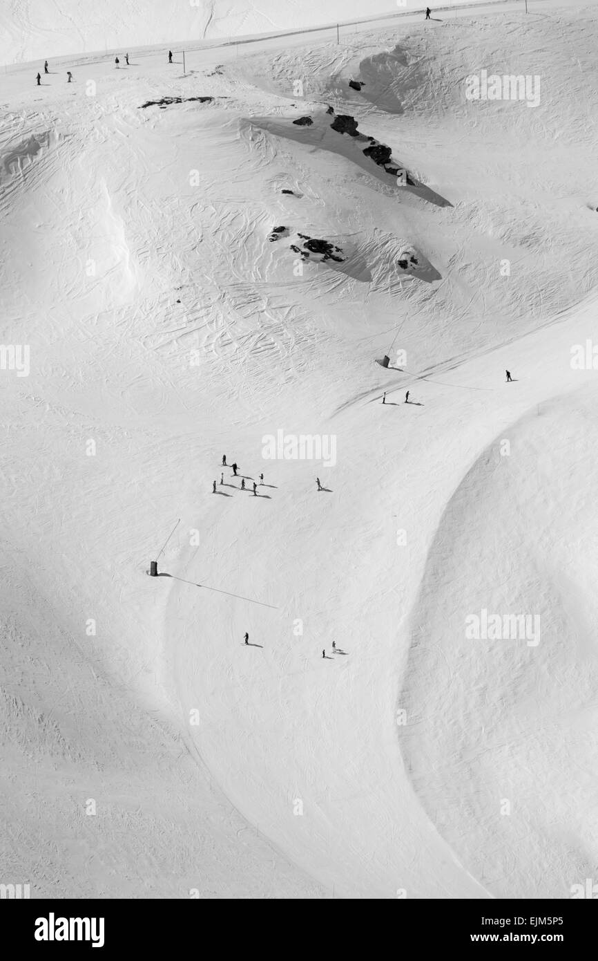 long range shot of skiers heading down the piste Stock Photo - Alamy