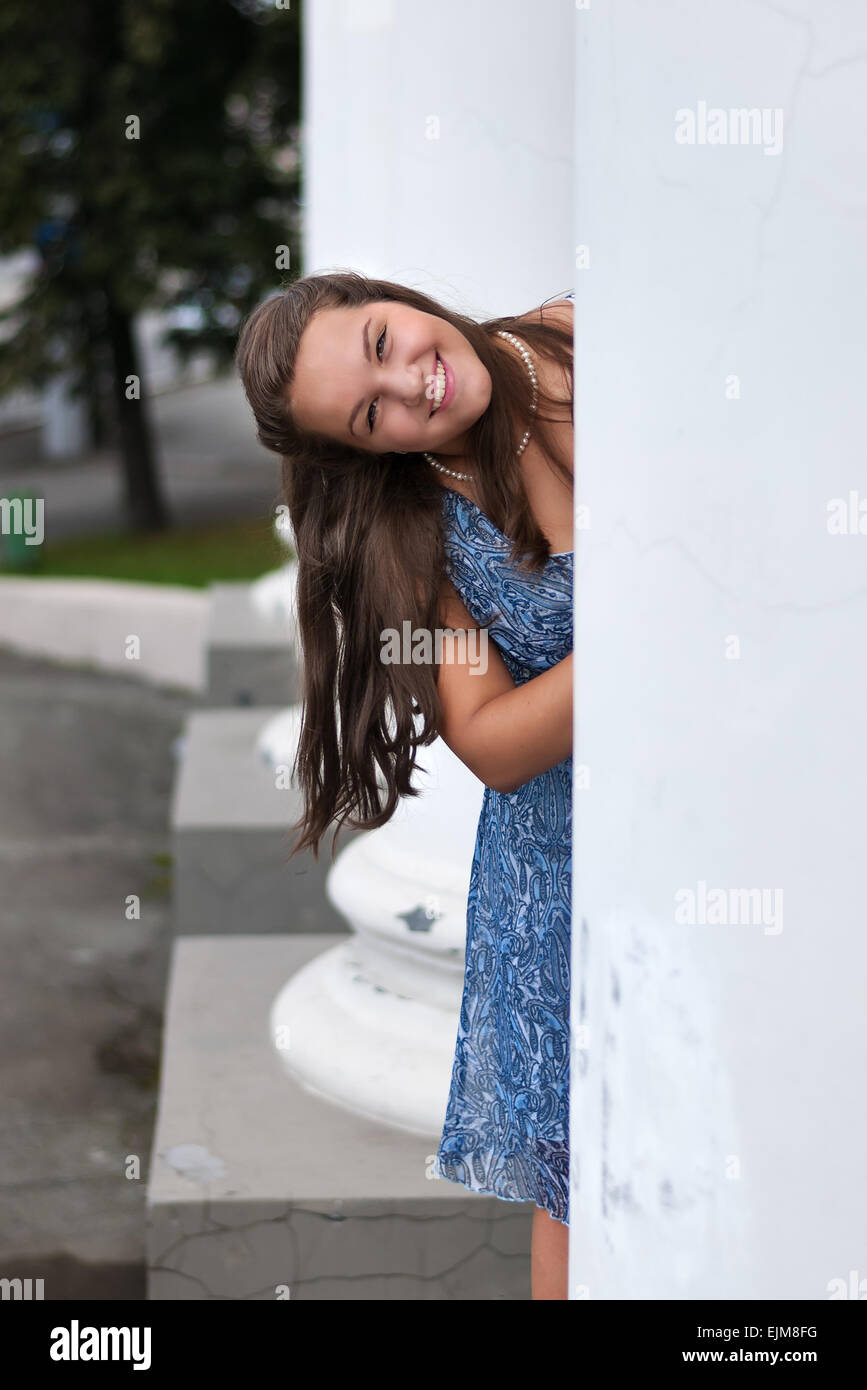 Young woman standing behind column hi-res stock photography and images ...