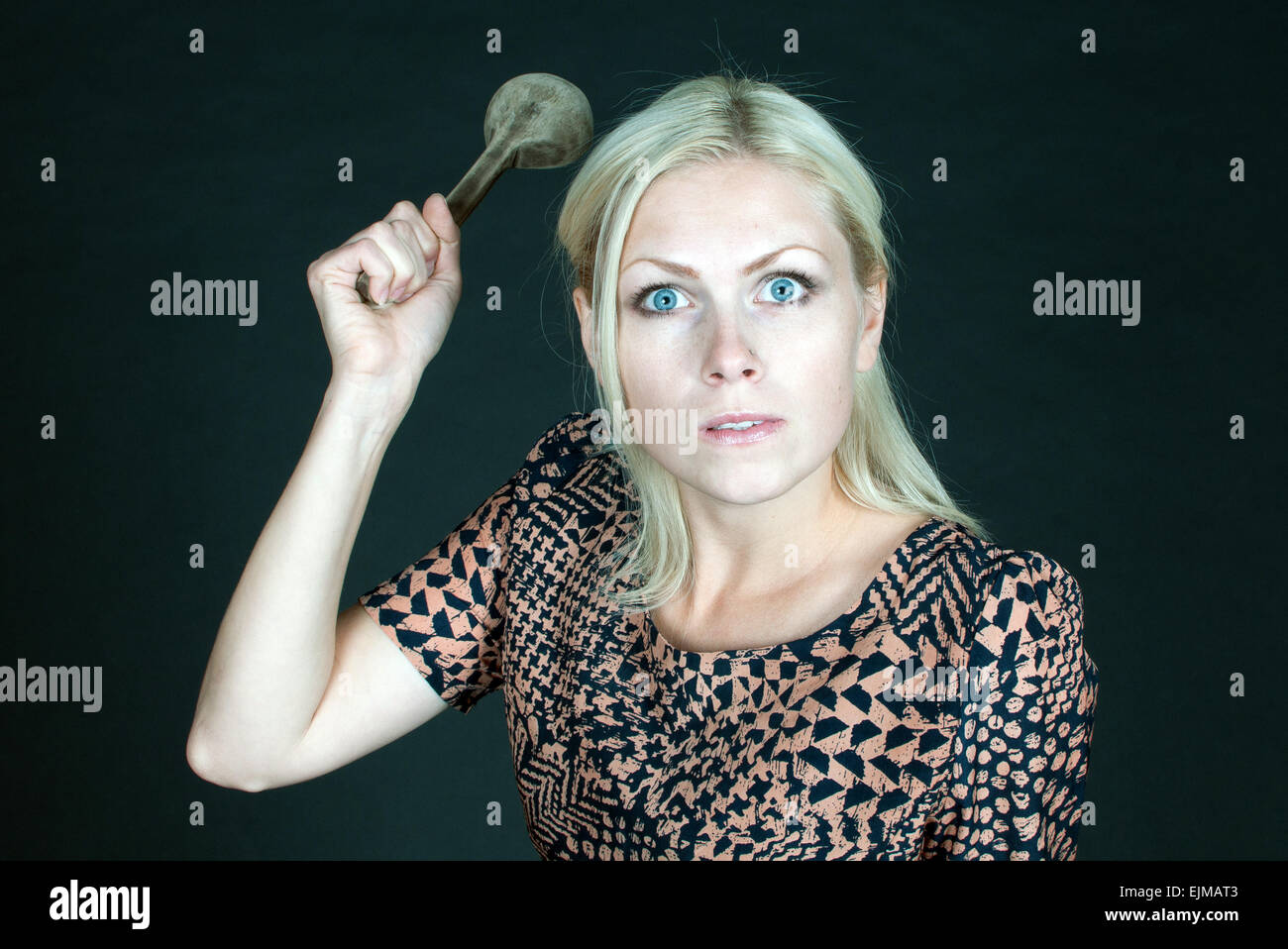 An angry woman swung spoon Stock Photo - Alamy
