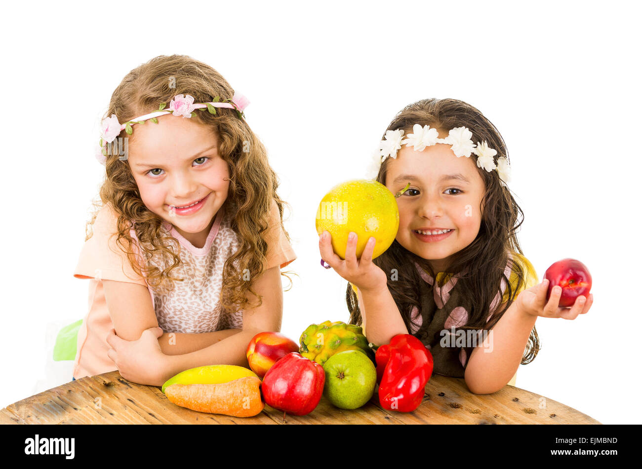 Beautiful healthy little girls holding delicious fresh fruits and ...