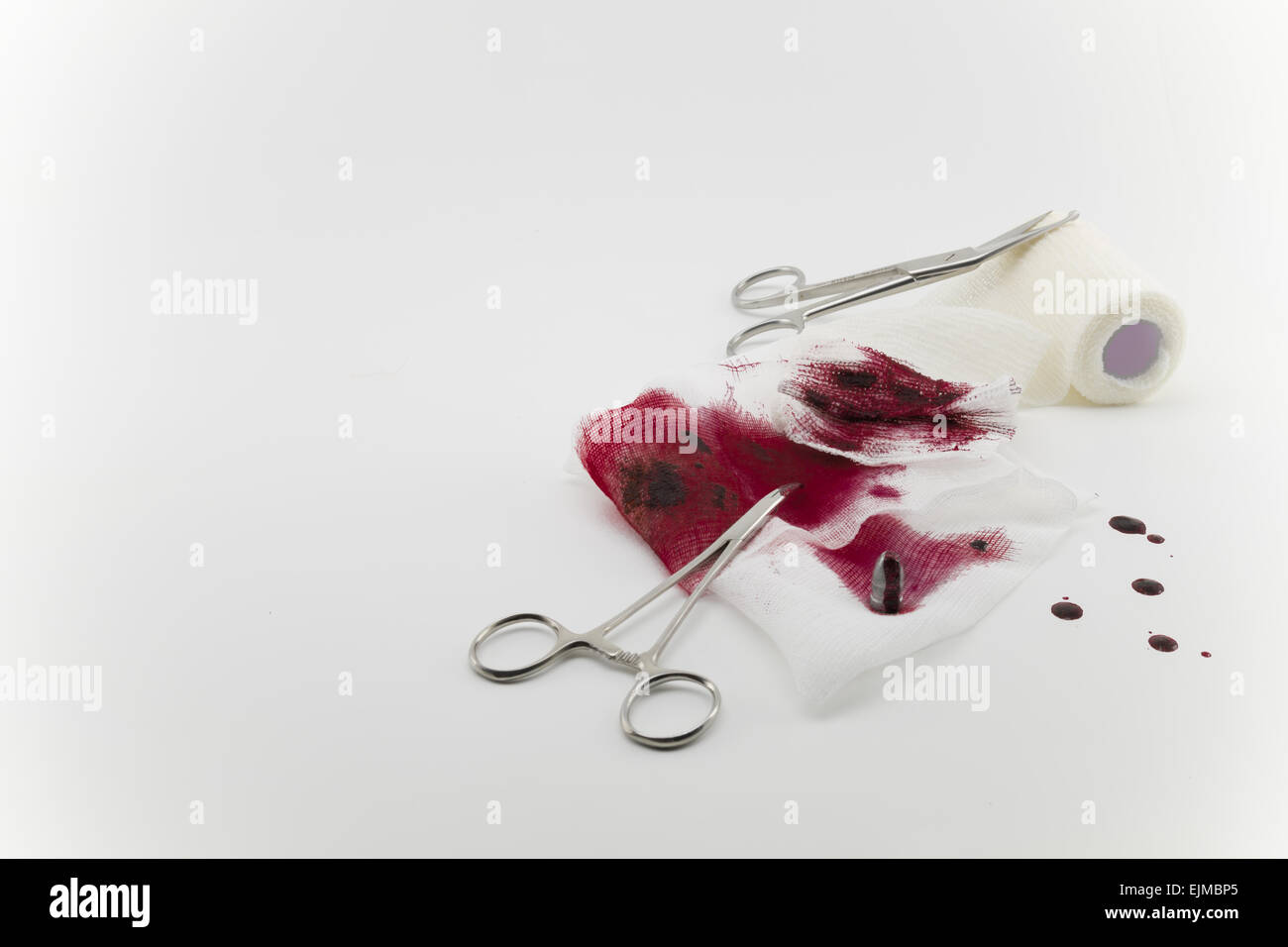 Surgical composition with bullet, blood and bandage Stock Photo - Alamy