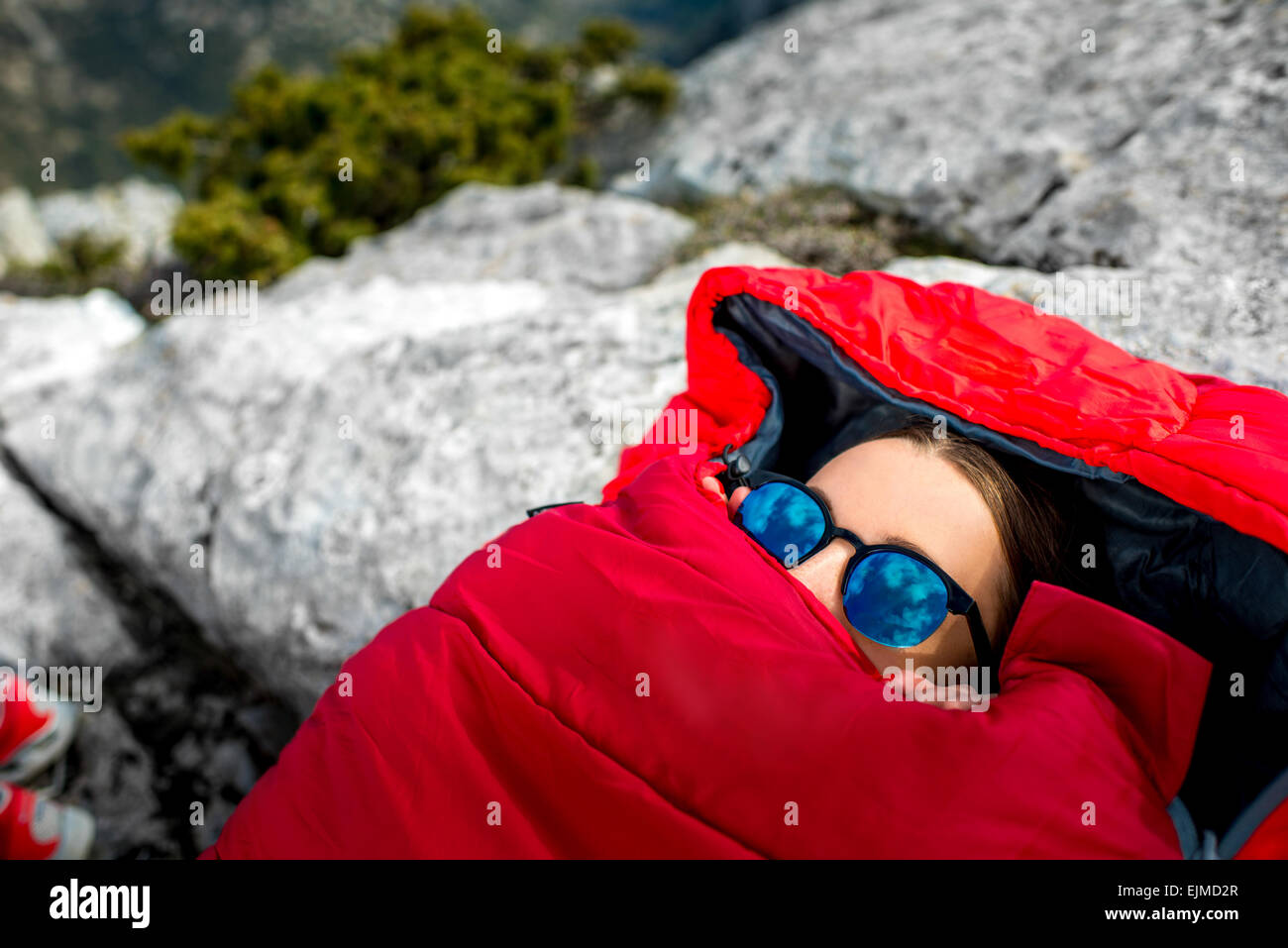 Woman in sleeping bag on the mountain Stock Photo - Alamy