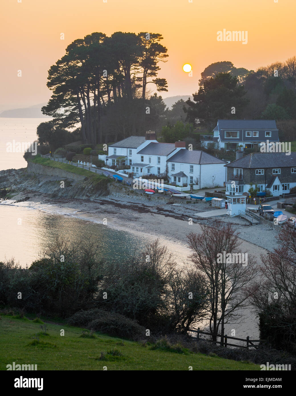 Sun setting over the riverside village of Helford Passage Cornwall ...