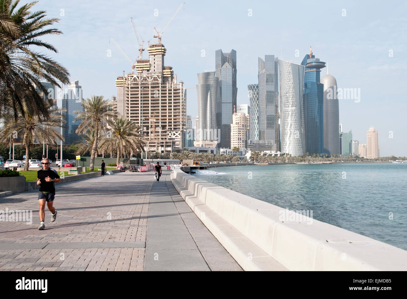 Pedestrians on the waterfront corniche in the city of Doha, in the gulf ...