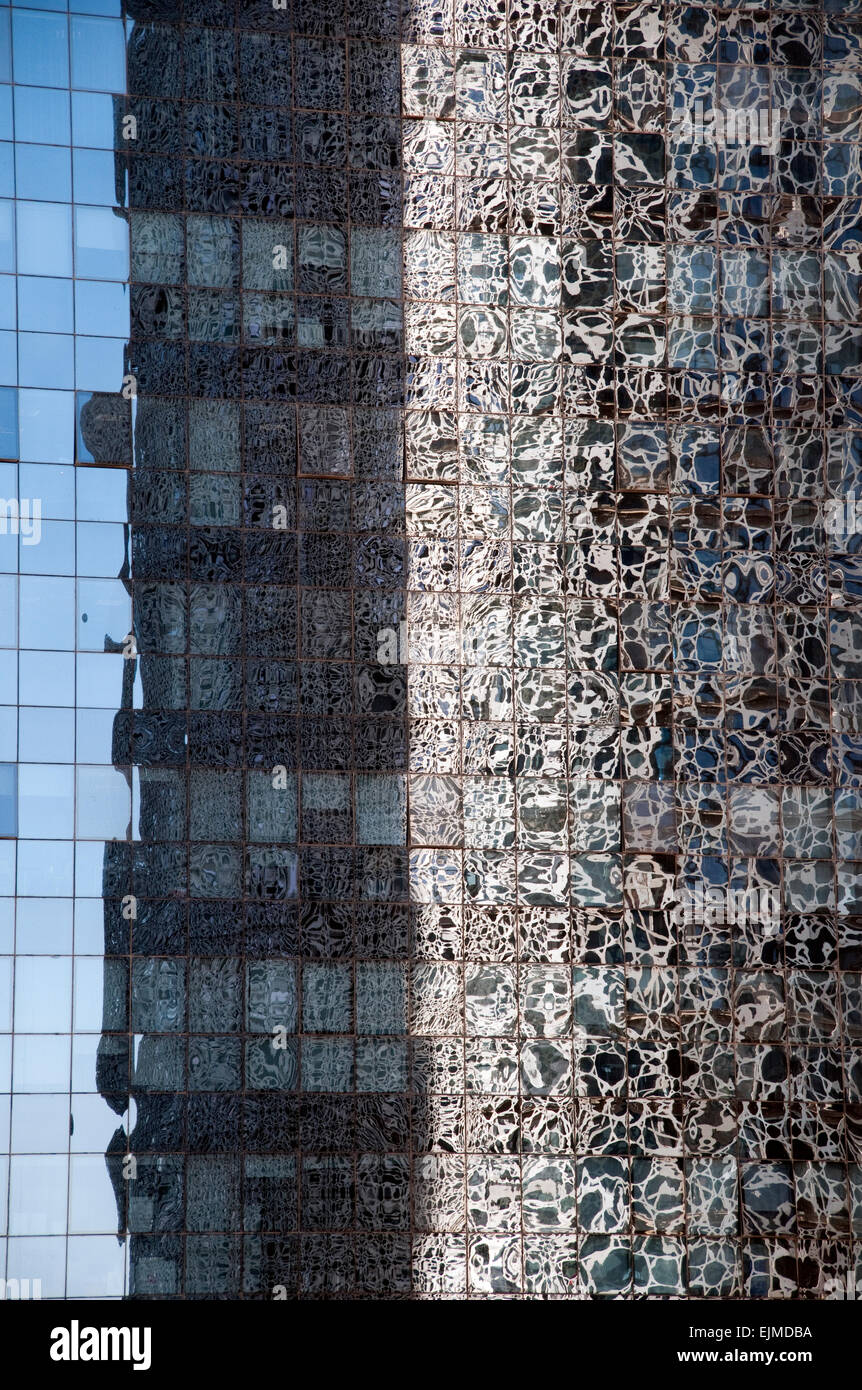 The exterior of the Doha Tower reflected in the window of a ...