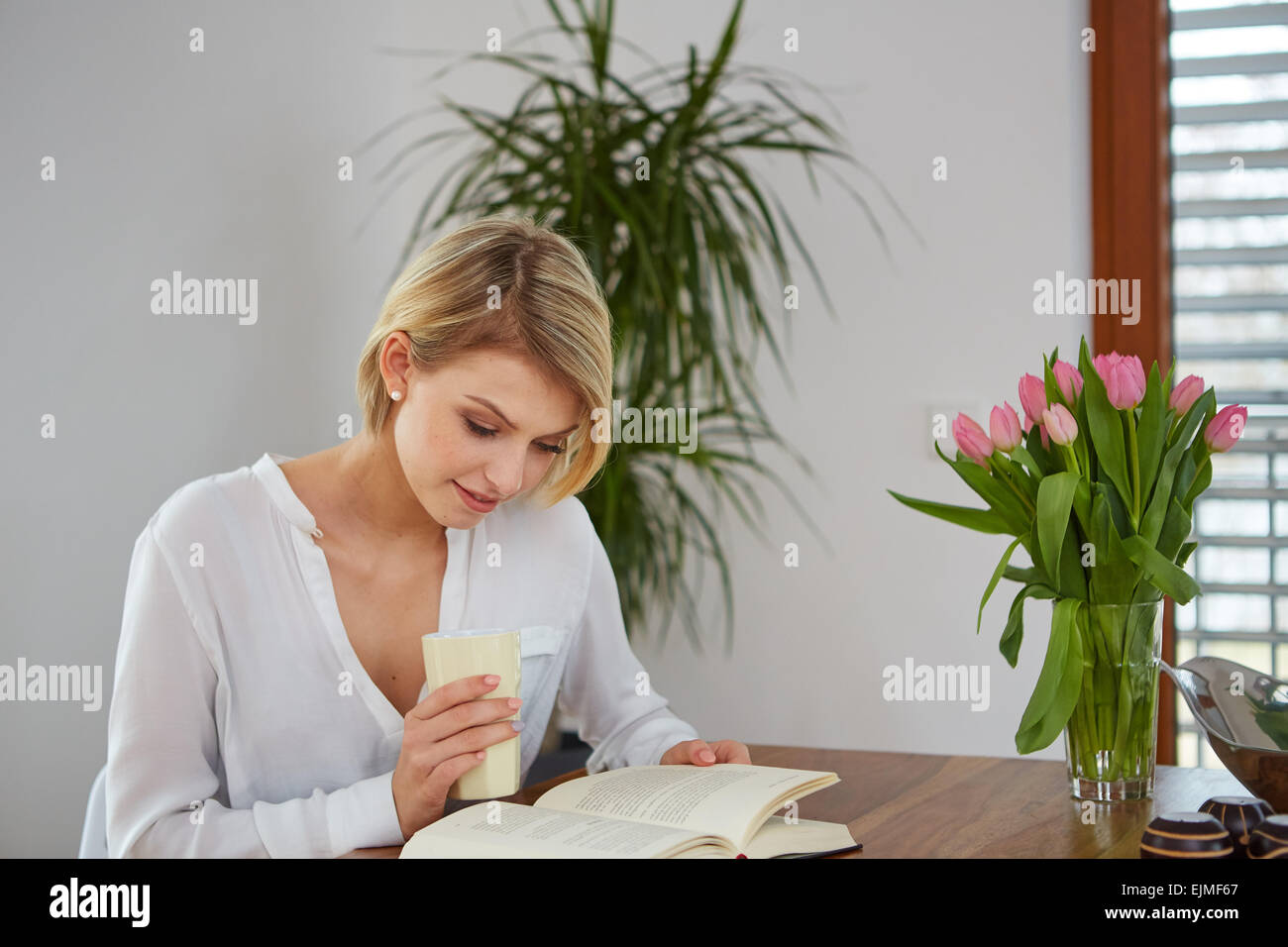 Beautiful woman reading her book Stock Photo - Alamy