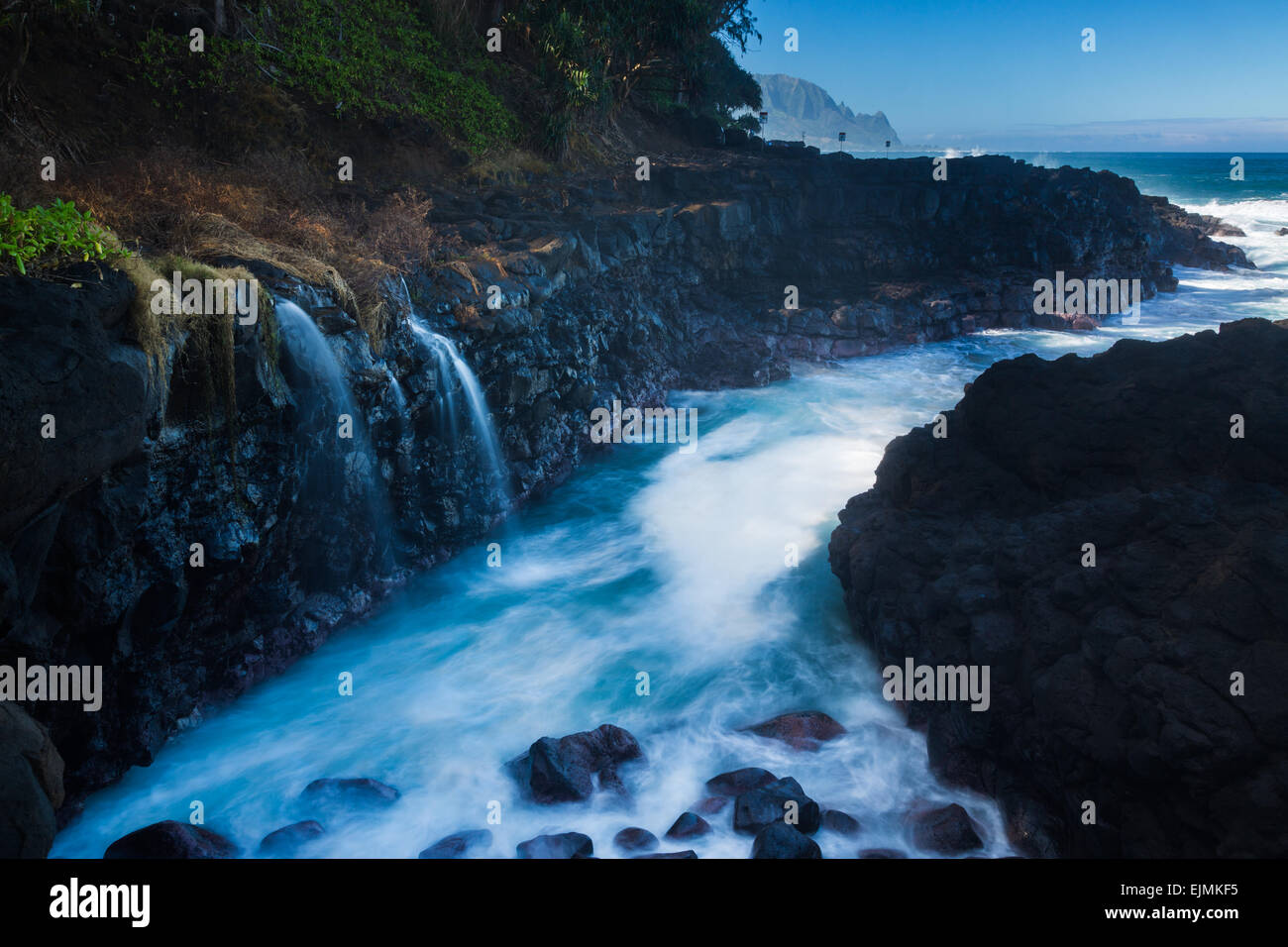 Waves crash into narrow gully by Queens Bath Princeville, Kauai, Hawaii ...