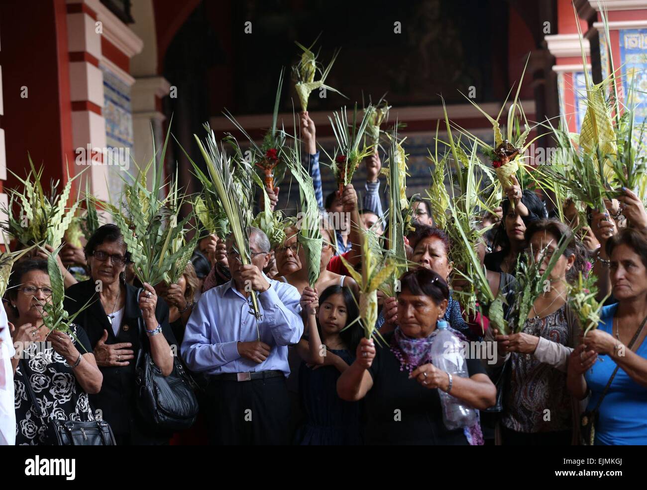 Lima, Peru. 29th Mar, 2015. People hold branches made with palms ...