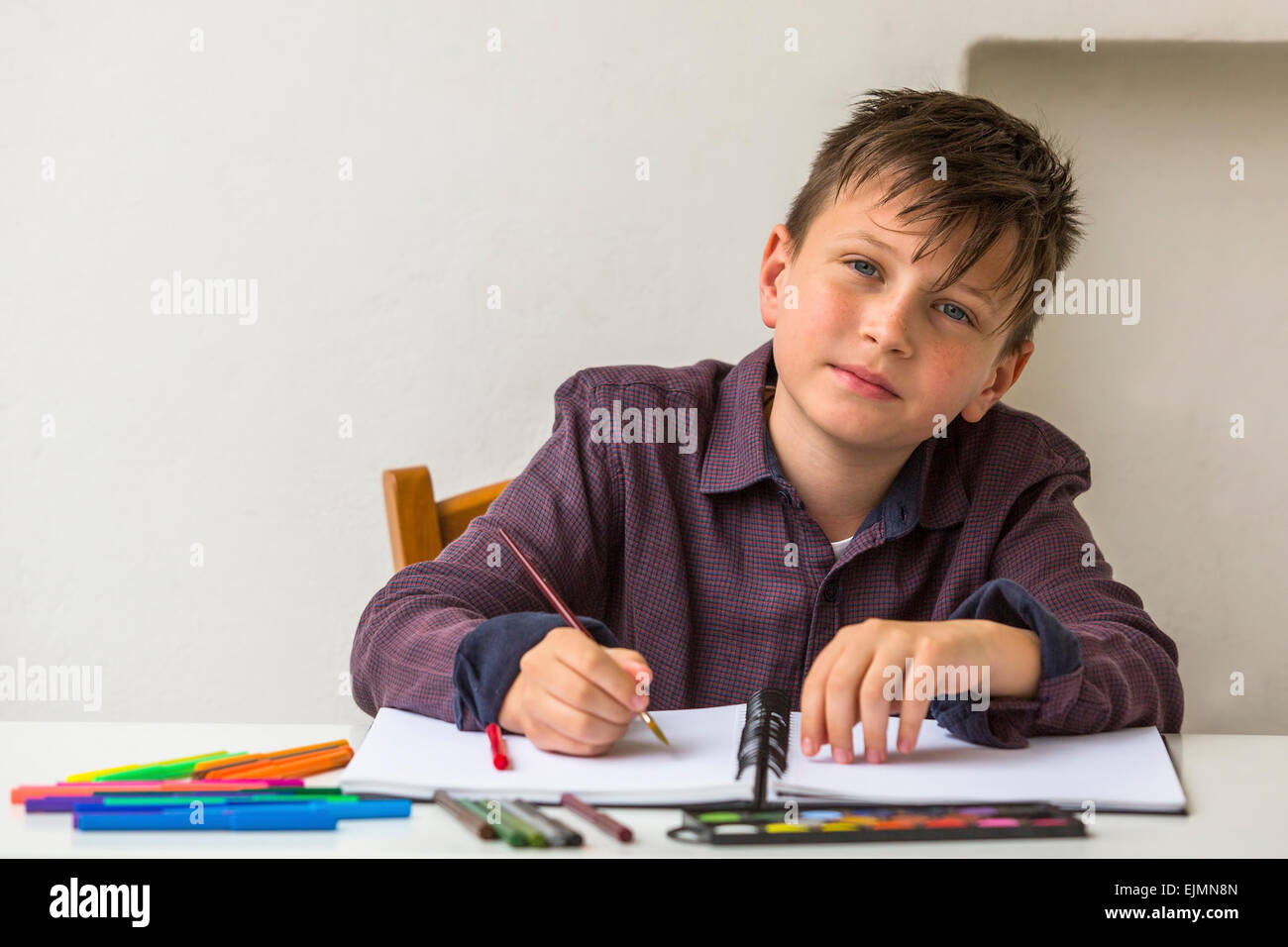 Boy sitting desk homework hi-res stock photography and images - Alamy