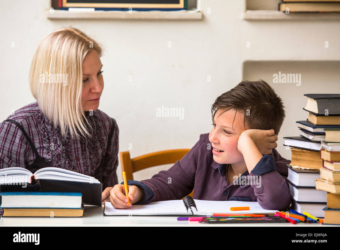 Tutor teaches a young student with his studies Stock Photo - Alamy