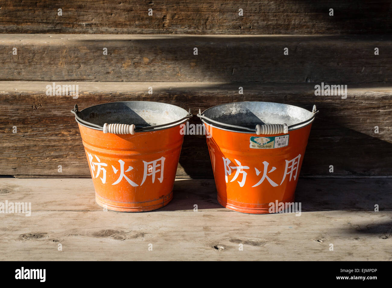 Two old orange Japanese fire buckets at a Buddhist temple in Nara ...