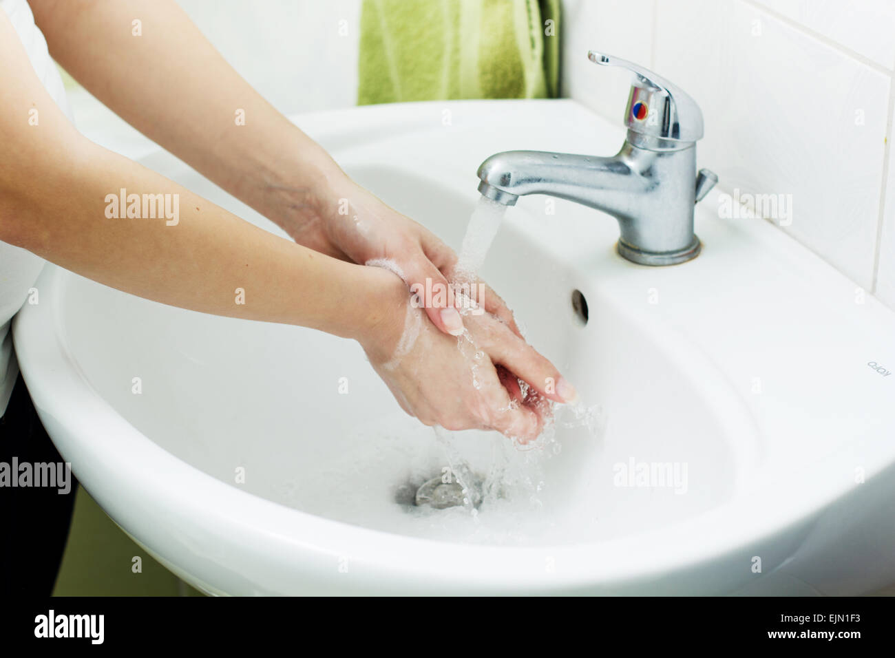 Washing Hands with streaming water in bathroom. Hygiene Stock Photo - Alamy