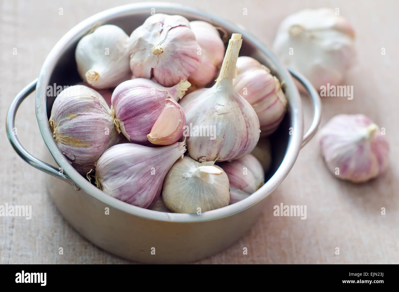 garlic in metal bowl on the table Stock Photo - Alamy