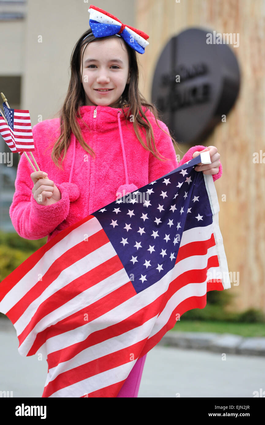 Girl with US flags came to welcome a group of US Army Stryker armored ...