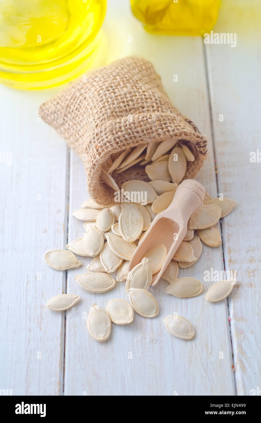 Dry pumpkin seed in sack, oil in glass bottle Stock Photo - Alamy