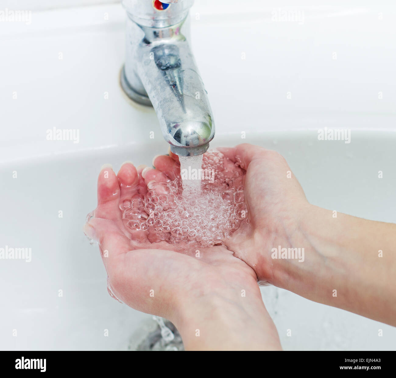 Washing Hands with streaming water in bathroom. Hygiene Stock Photo - Alamy