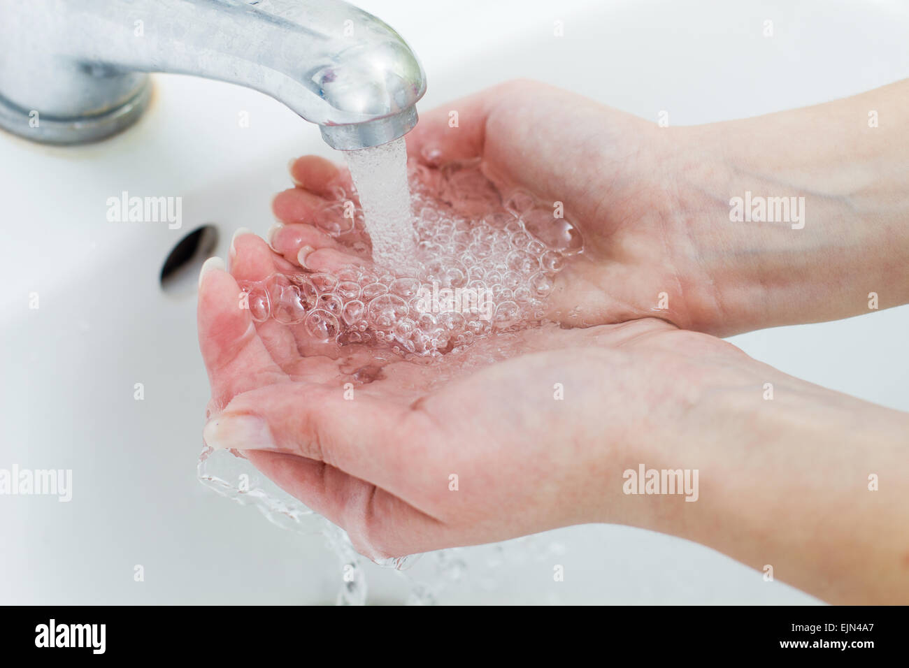 Washing Hands with streaming water in bathroom. Hygiene Stock Photo - Alamy