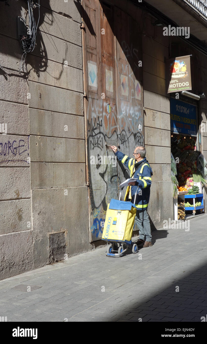 Spanish postman delivering letters in El Raval area of Barcelona Stock ...