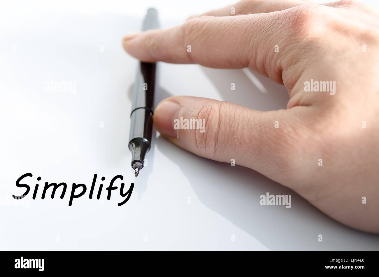 Human hand writing Simplify isolated over white background - business ...