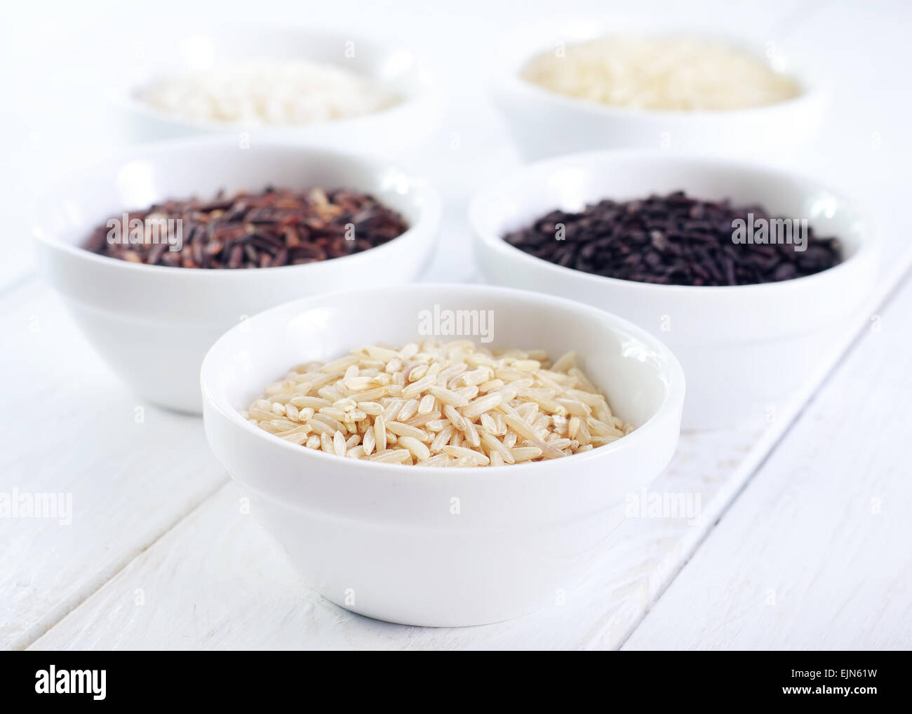 Different kind of raw rice, raw rice in the white bowls Stock Photo - Alamy