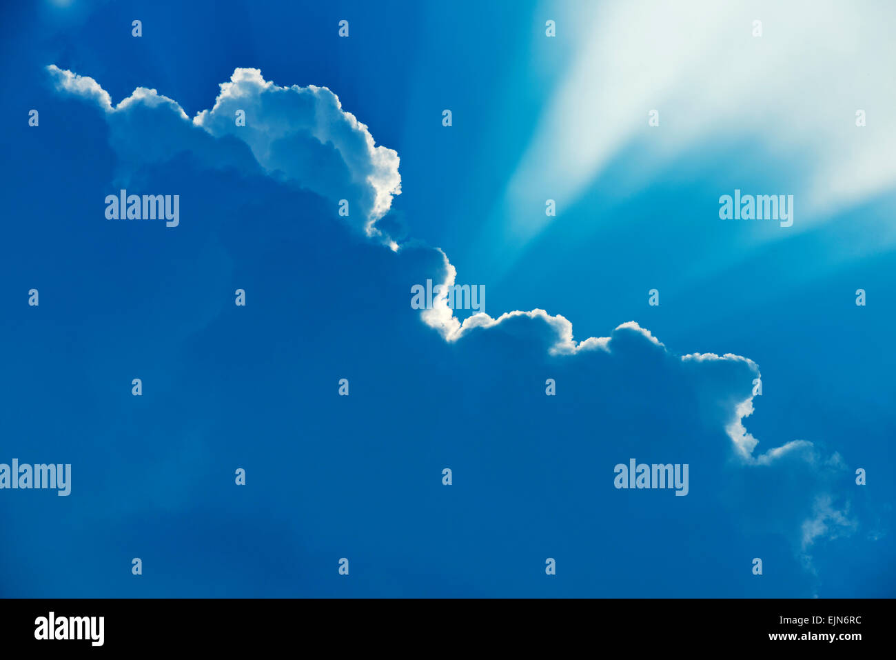 Beautiful rays of light streaming from behind the clouds Stock Photo ...