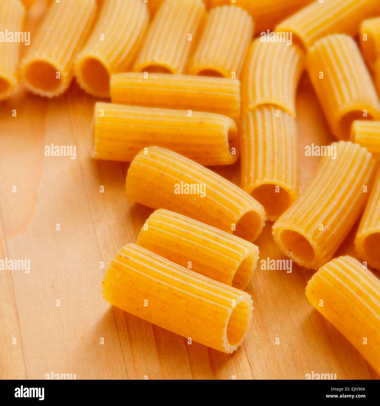 a pile of uncooked penne rigate on a table, ready to be boiled Stock ...