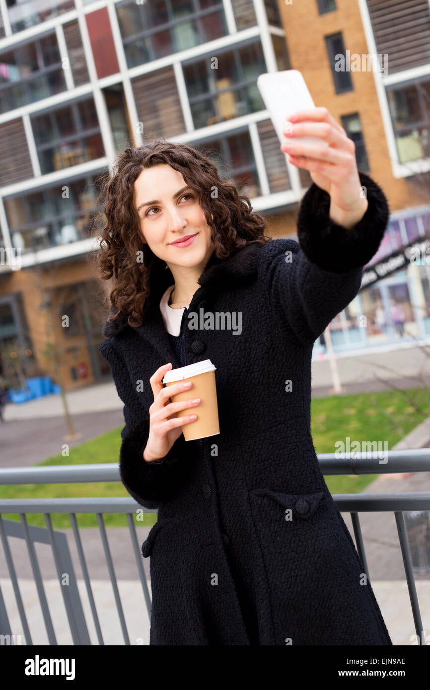 Smiling beautiful brunette taking selfie hi-res stock photography and ...