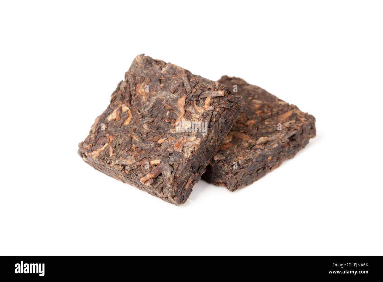 Two pressing briquette of black Chinese Shu Pu Erh tea isolated on ...