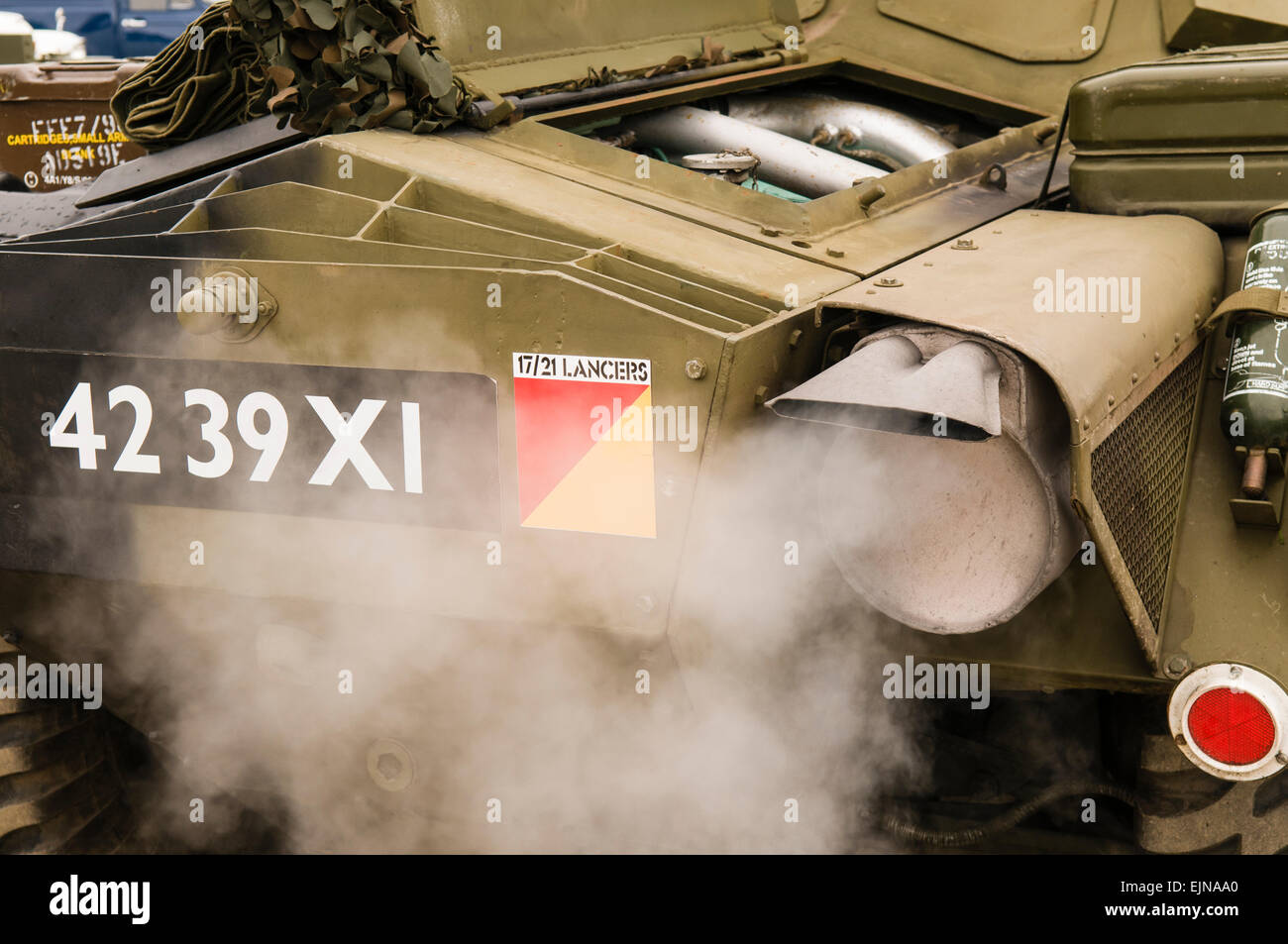Dense smoke billows from the exhaust of a military tank Stock Photo - Alamy