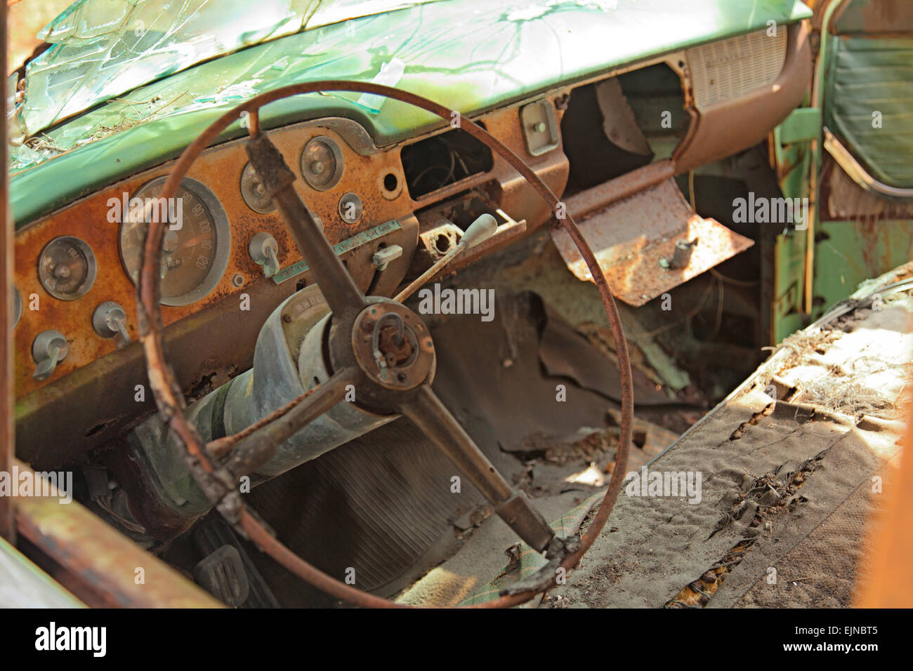 Car graveyard in Florida. Several old, defunct and rusty automobiles ...