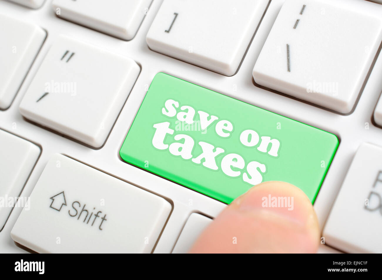 Pressing green save on taxes key on keyboard Stock Photo - Alamy