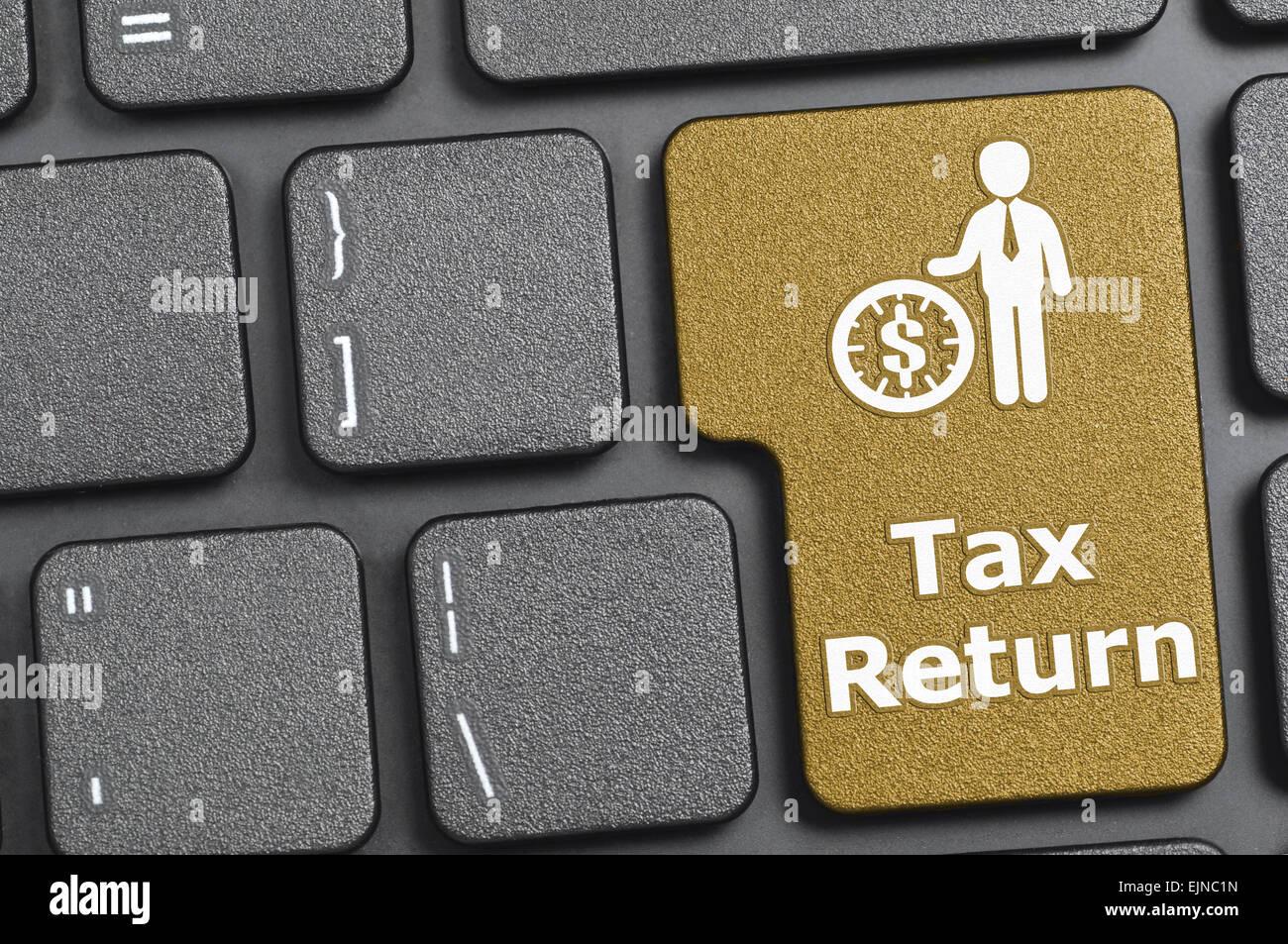 Brown tax return key on keyboard Stock Photo - Alamy