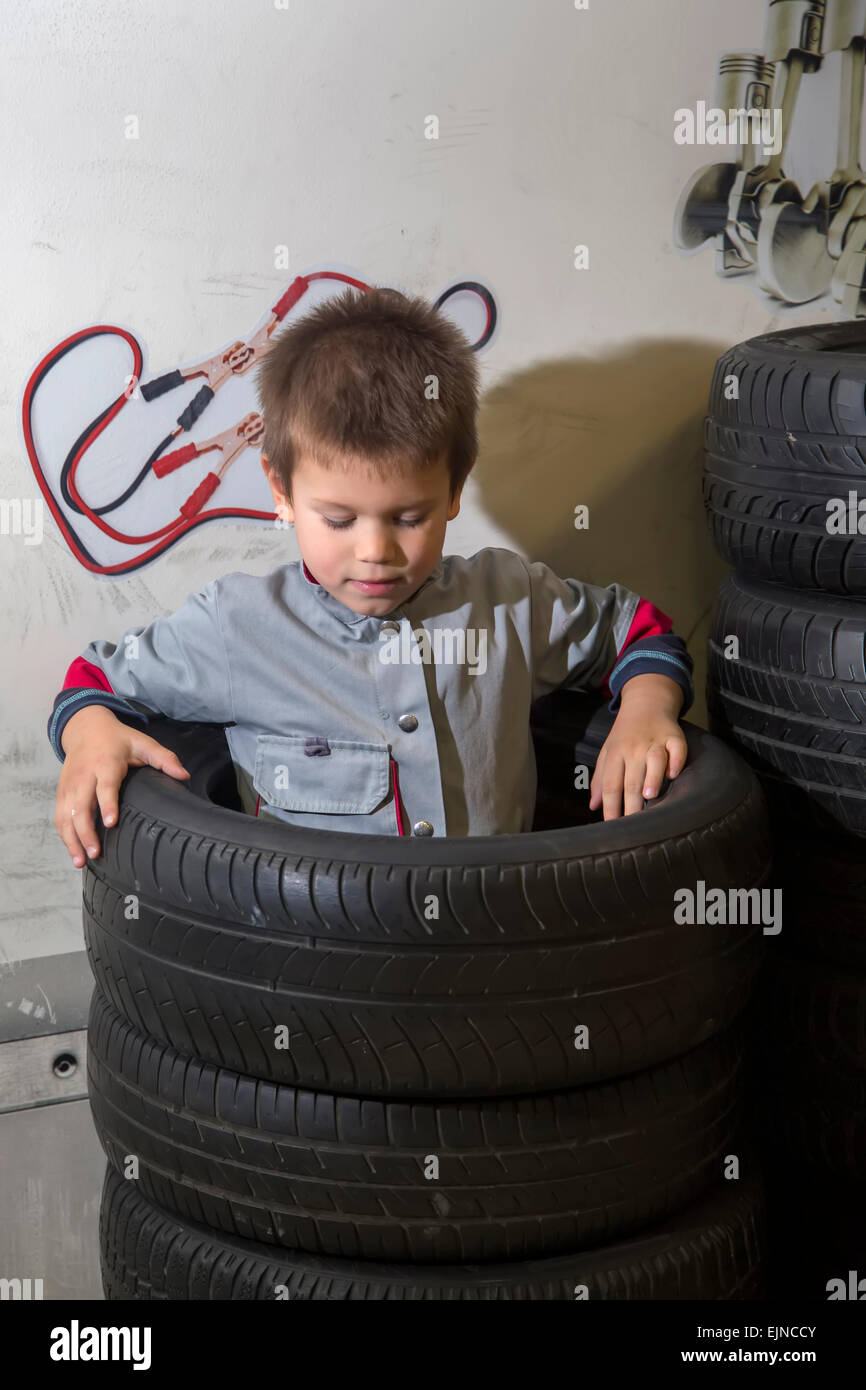 Boy in the auto repair shop Stock Photo - Alamy
