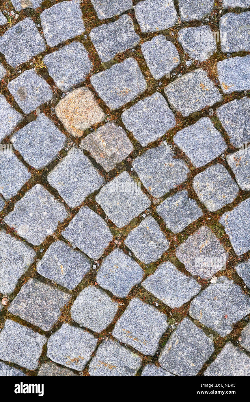 Granite cobbled road with one discolored stone Stock Photo - Alamy