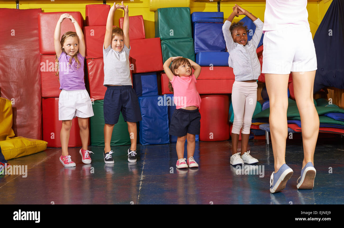 Kids gymnastics with group of children in physical education with PE ...