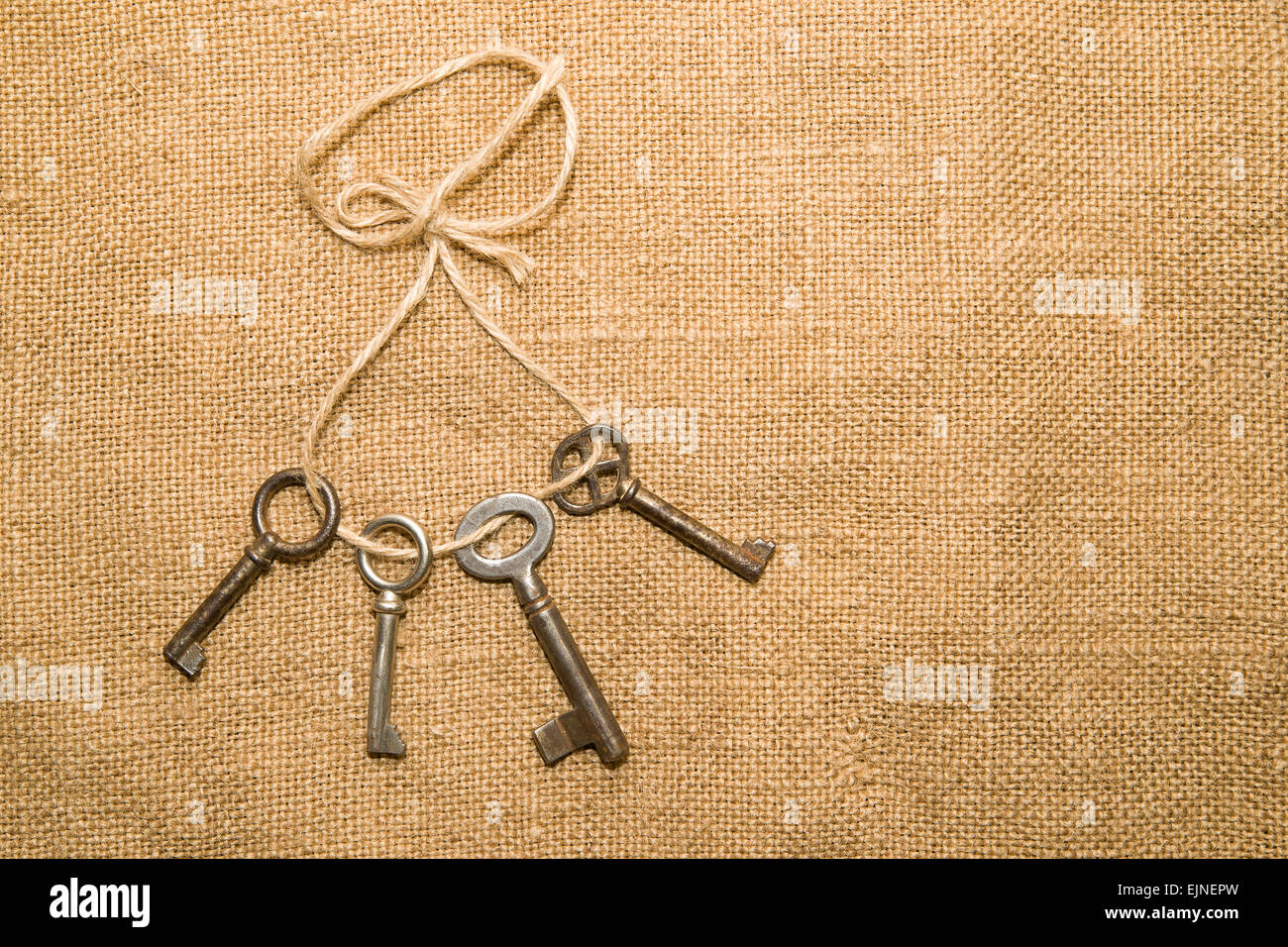 Four old keys tied with a rope on old cloth Stock Photo - Alamy