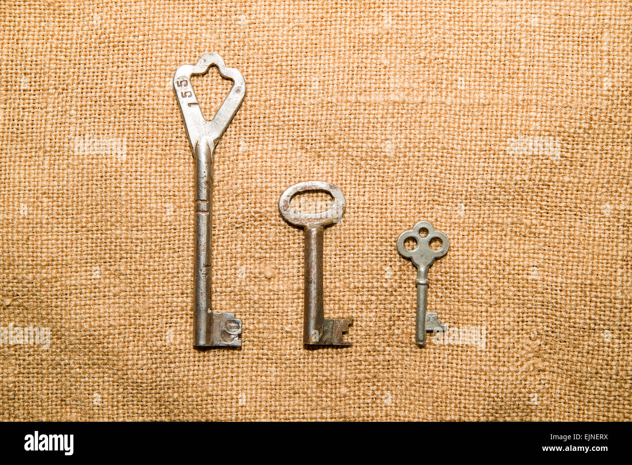 Three vintage keys to the safe on old cloth Stock Photo - Alamy