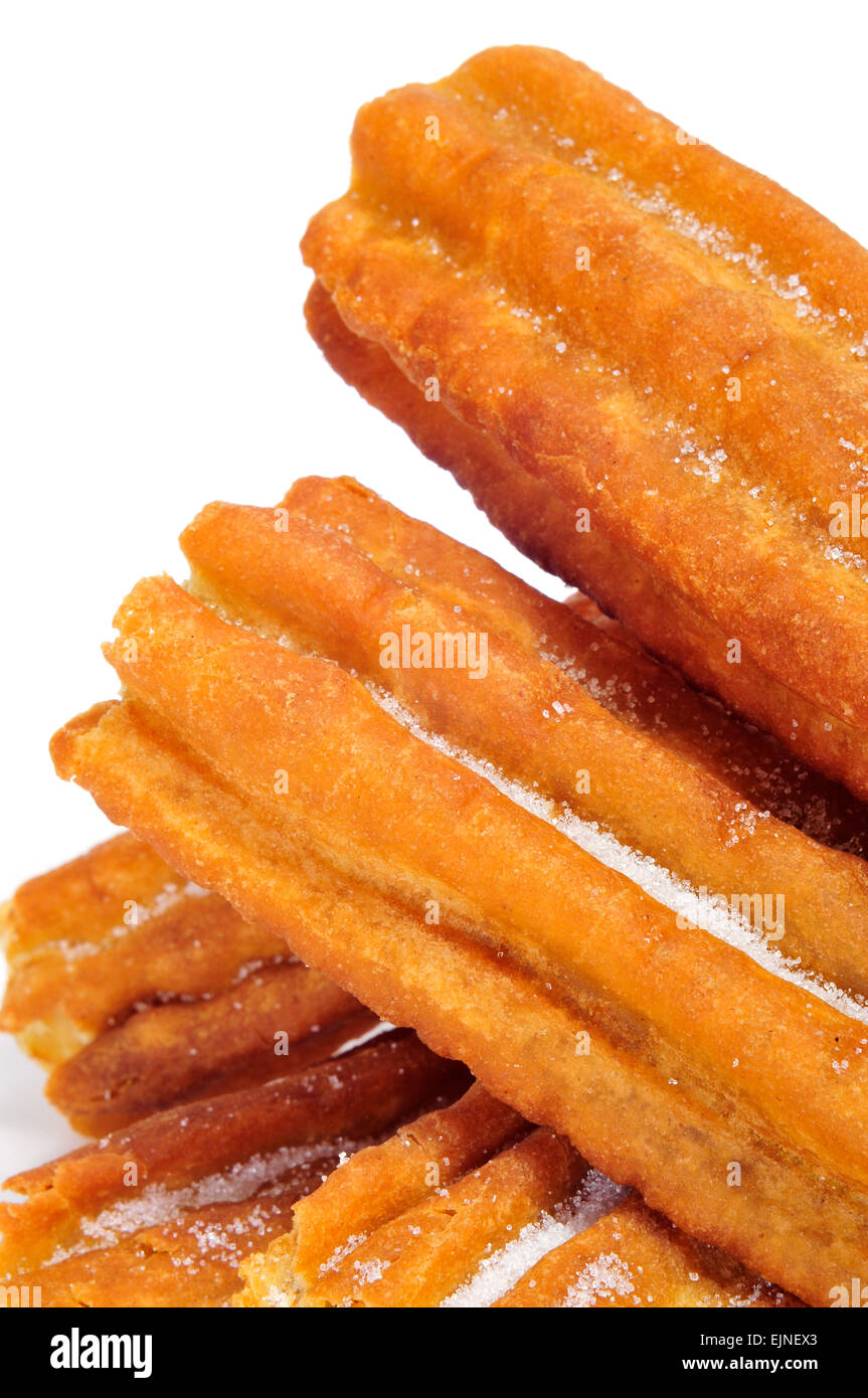 a pile of porras, thick churros typical of Spain, on a white background ...