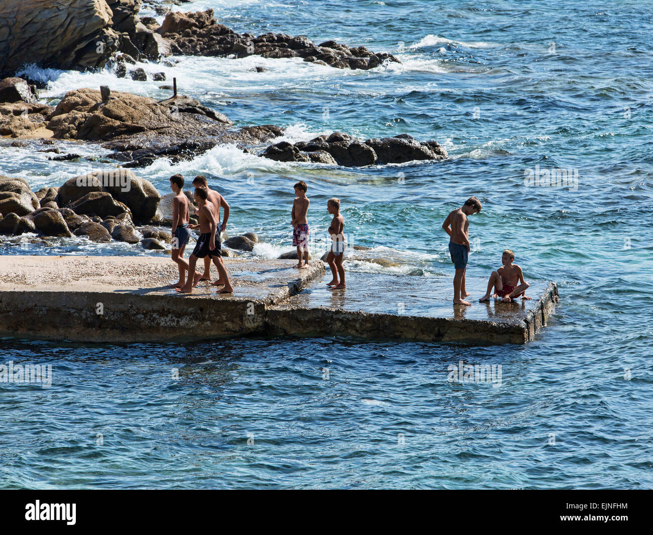 Mykonos, Greece boys playing on Mediterranean Ocean pier Stock Photo ...