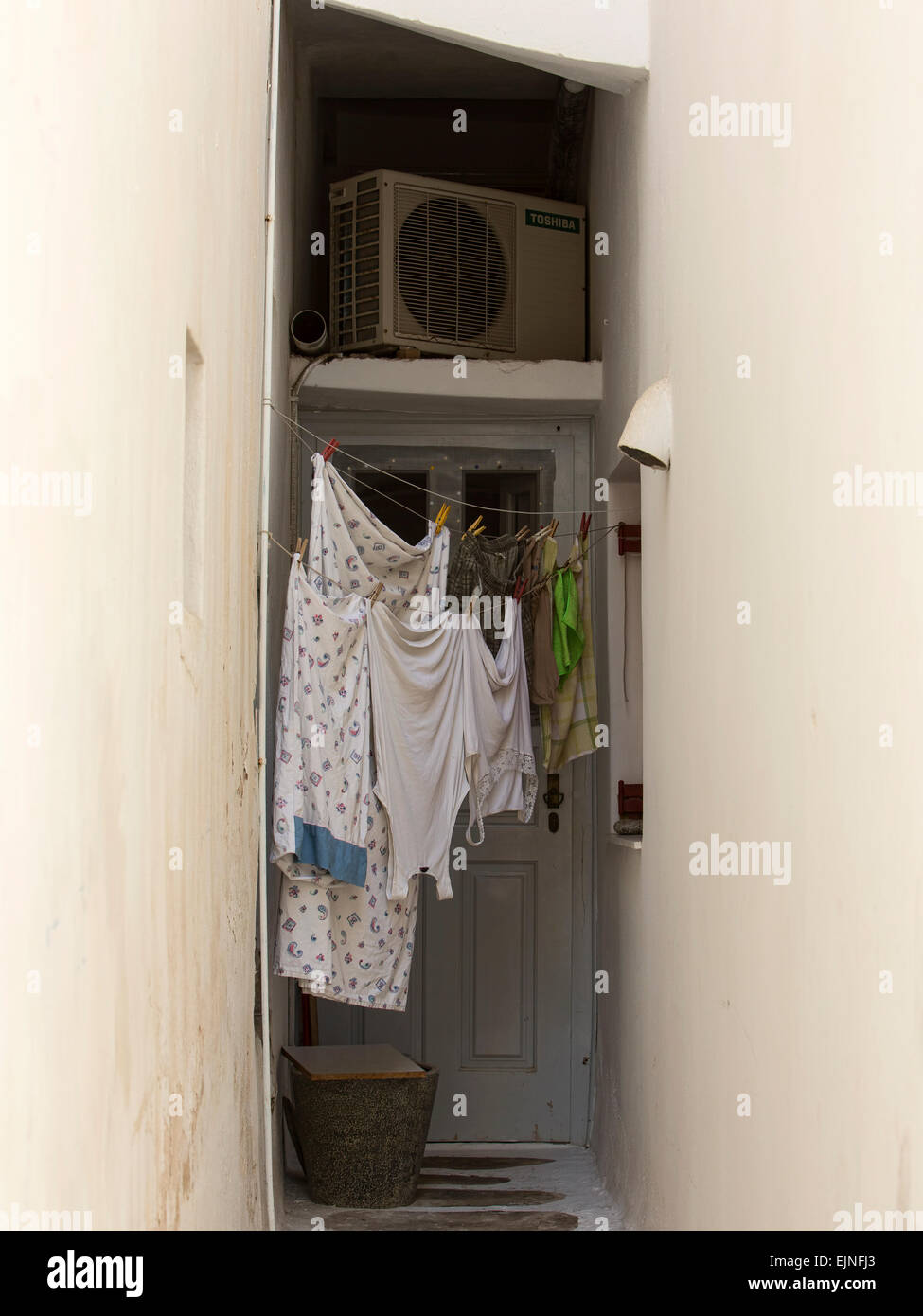 Mykonos, Greece clothes hanging from alley door Stock Photo - Alamy