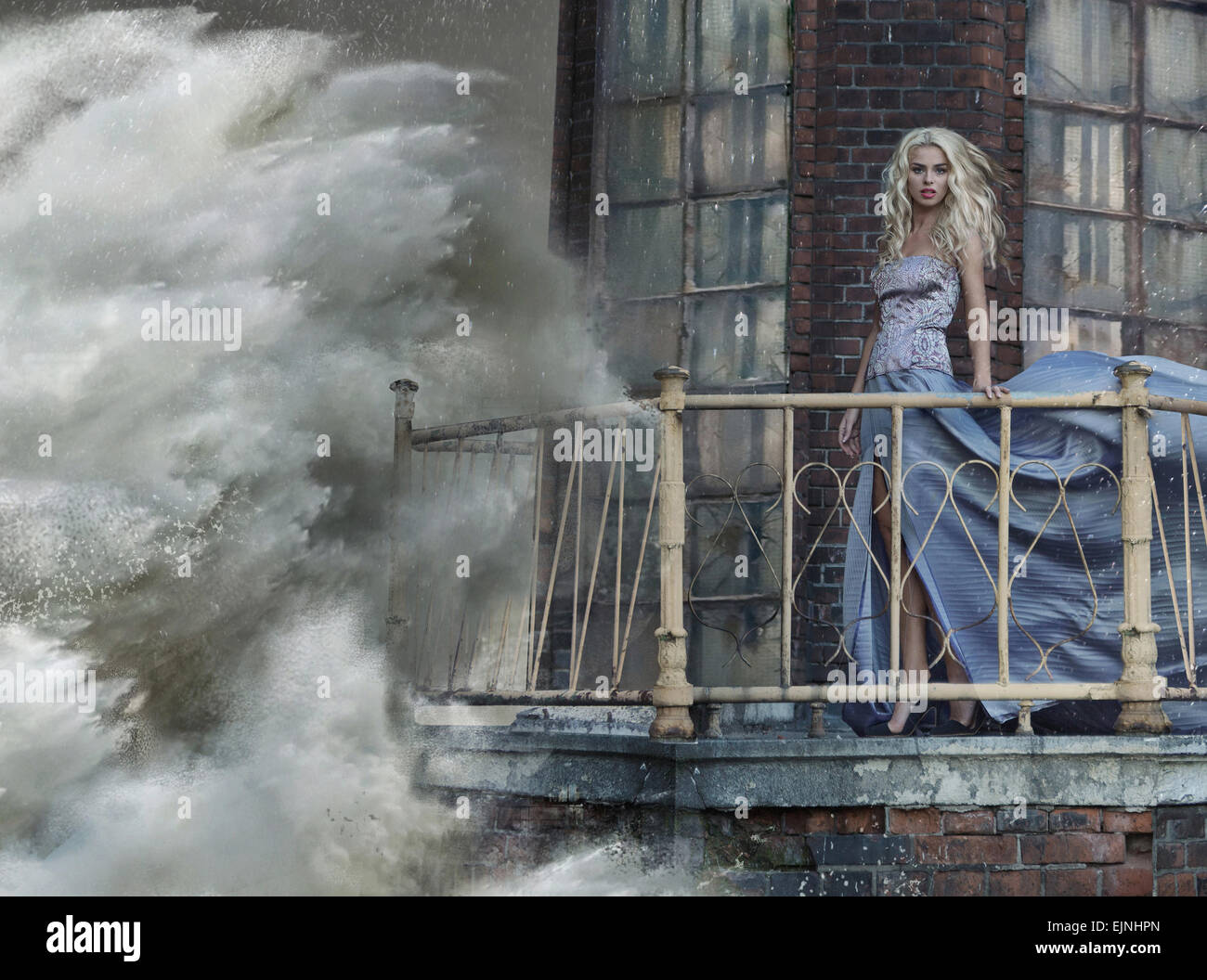 Portrait of an amazing lady standing on lighthouse during the storm ...