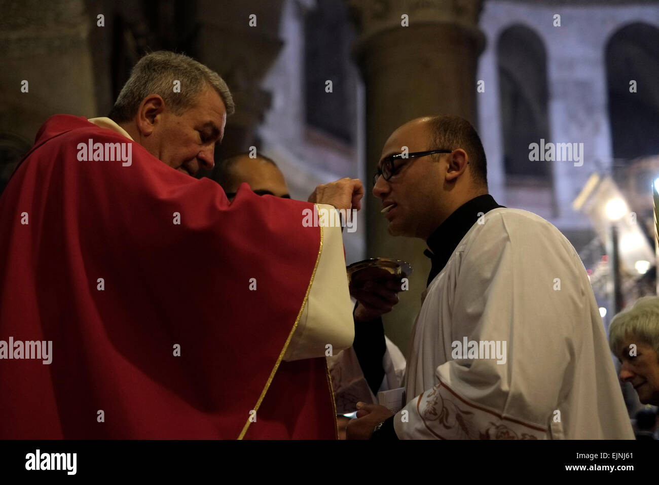 Roman Catholic clergy gives out holy communion during Sunday mass ...