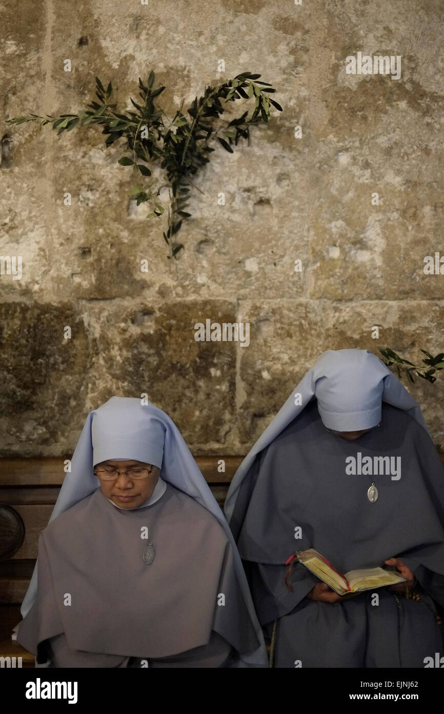 Catholic nuns praying on Palm Sunday in the Church of Holy Sepulchre in ...