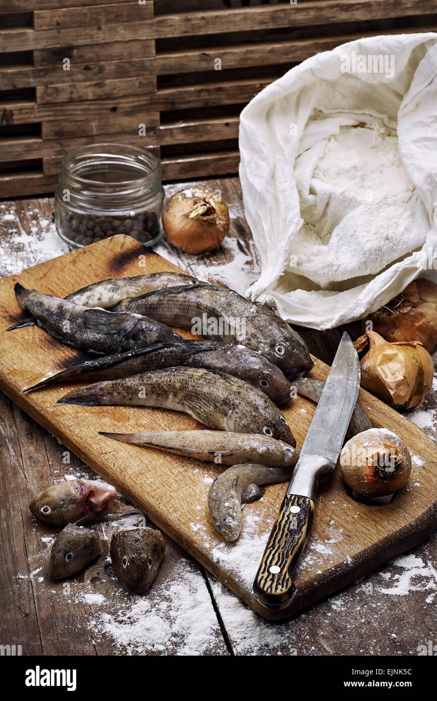 fish breed bull next to the bag of flour on the table wooden table ...