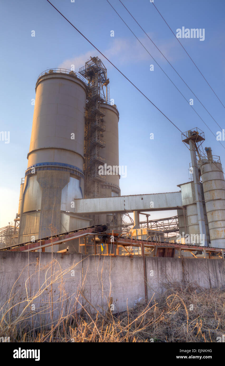 Cement factory on sunset - view to the silos and production yard Stock ...
