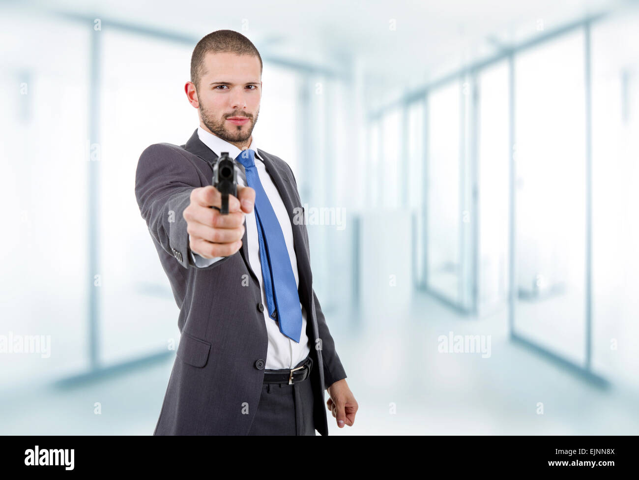 young businessman with a gun, at the office Stock Photo - Alamy