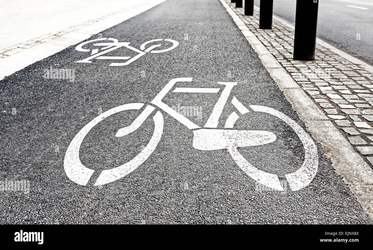 White painted bike path signs on asphalt Stock Photo - Alamy